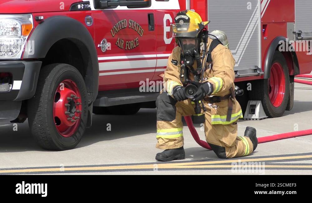 U.S. Air Force fire fighter adjusting nozzle on water hose Stock Video ...