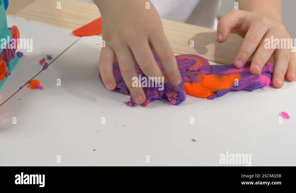 A 2-year-old preschool kid playing with modeling clay (compound Stock ...