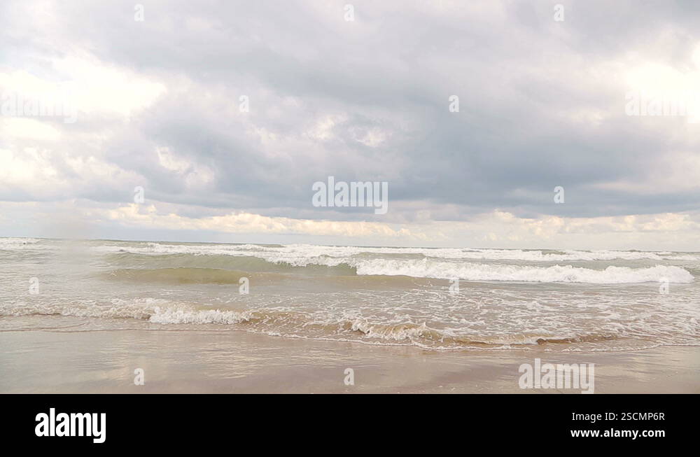 Close up of small wave crushing on the beach and moving towards camera ...
