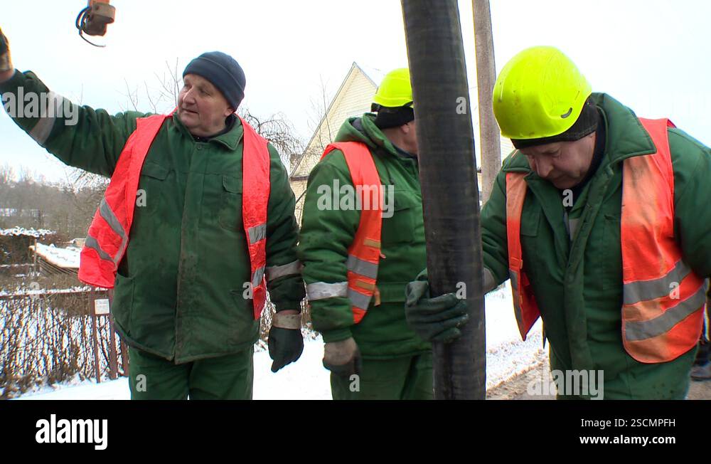 Faeces removal team with special equipment work on street in winter ...