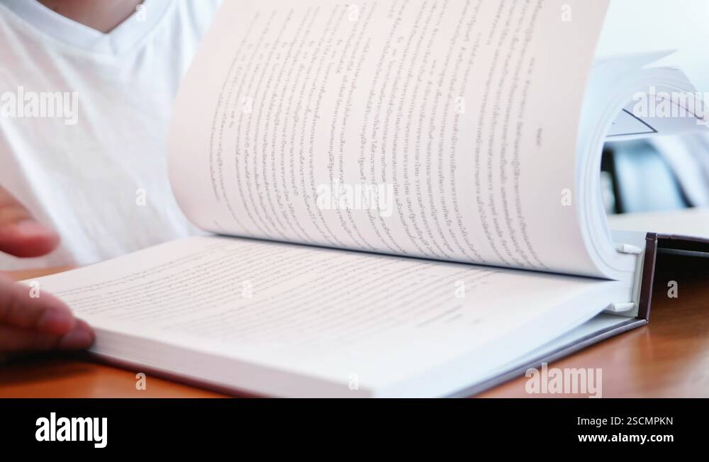 Opening books to find information by trying to open many pages slow motion Stock Video Footage ...