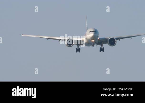 Footage of airplane landing, front view, long shot. Airliner descending ...