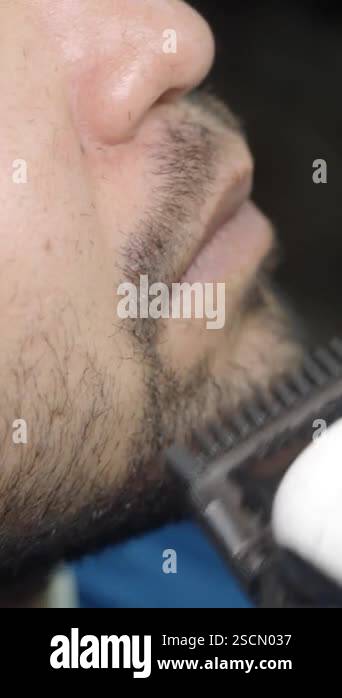 Trimming facial hair for a clean look in close-up Stock Video Footage ...