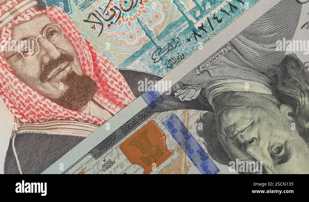 Saudi Arabia riyal against US dollar bill rotating. Saudi Arabia and ...