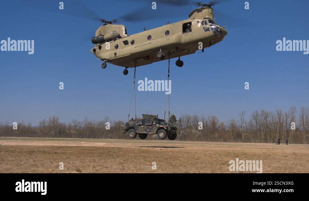 CH-47 Chinook lowering Humvee jeep during sling load exercise Stock ...