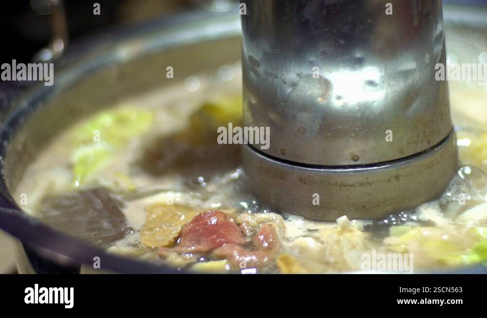 Slow Motion of traditional Beijing hot pot with a donut-shaped brass ...