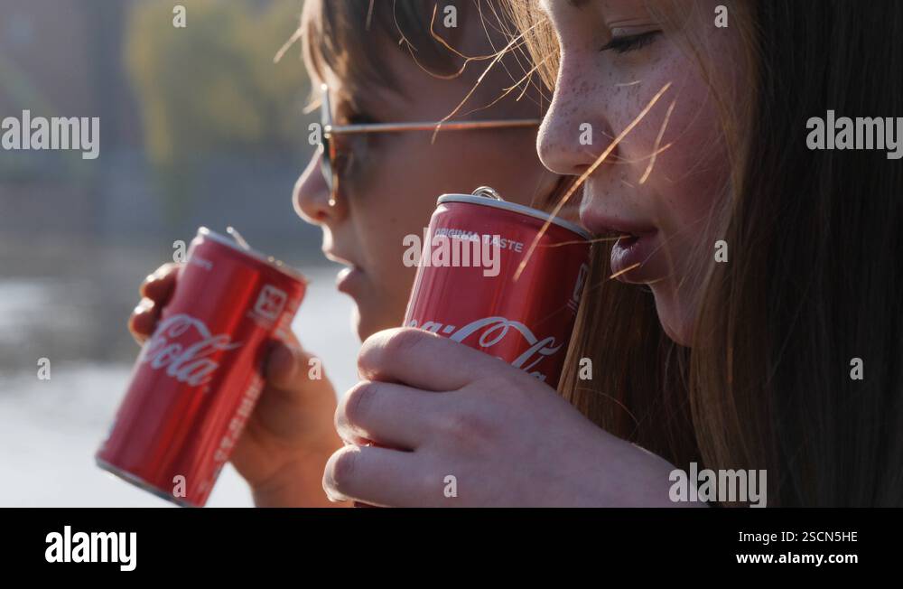 Teenager young kids friends boy and girl drinking cola can the ...