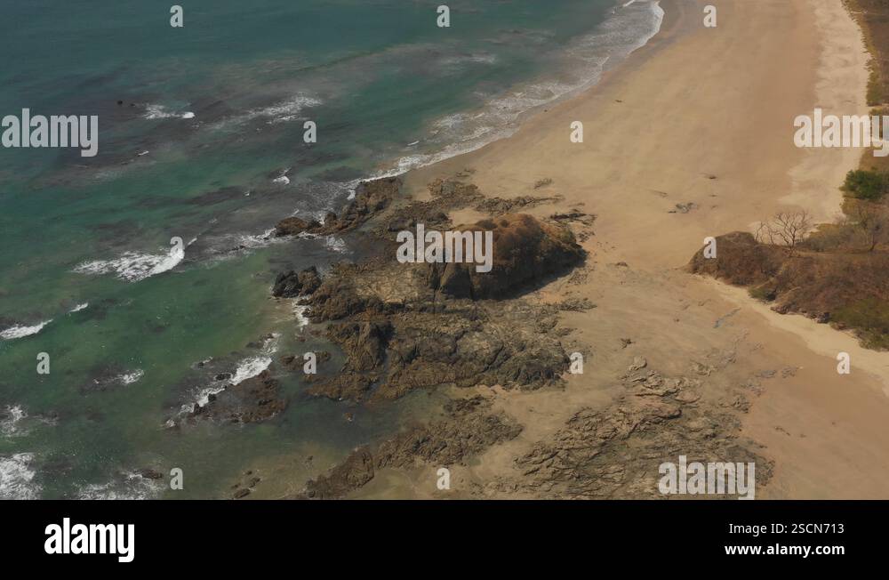 Drone flight over large coastal rock and outcrop. Pacific Ocean, Costa ...