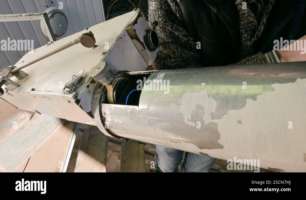 Close-up A professional engineer observer of a solar coronagraph at a ...