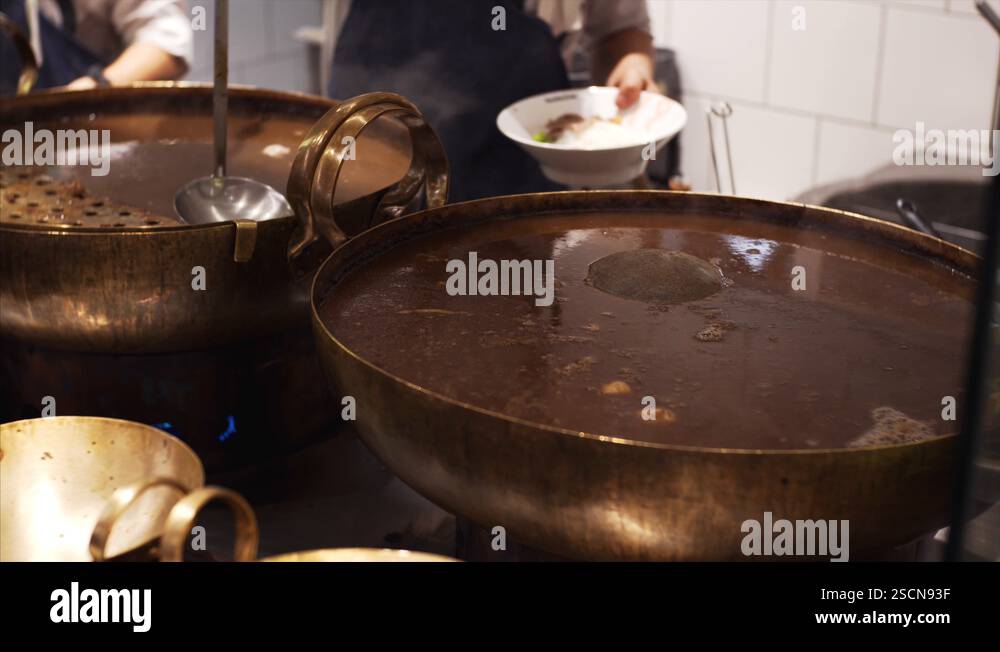 Unidentified waiter puts thai soup in customer's plate in Bangkok food ...