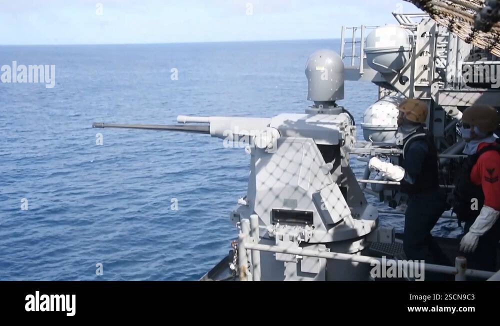 Marine firing machine gun from USS Boxer LHD 4 during live fire exerise ...