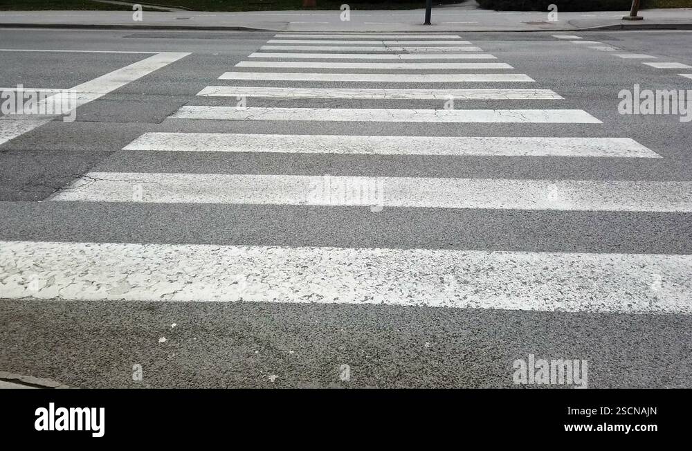 Filming while waiting at road pedestrian crossing with old worn out ...