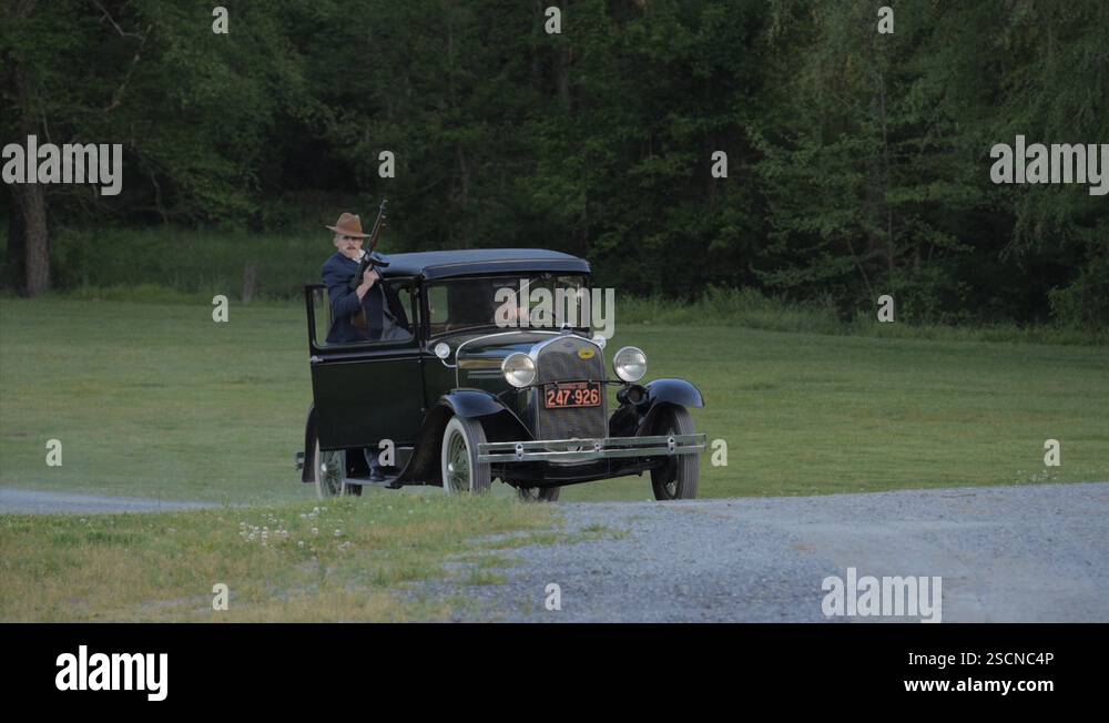 Mobster rides a vintage Ford Model A Car driving during prohibition ...