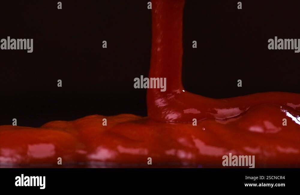 Ketchup pouring over black background. Food backdrop. Tomato red ...