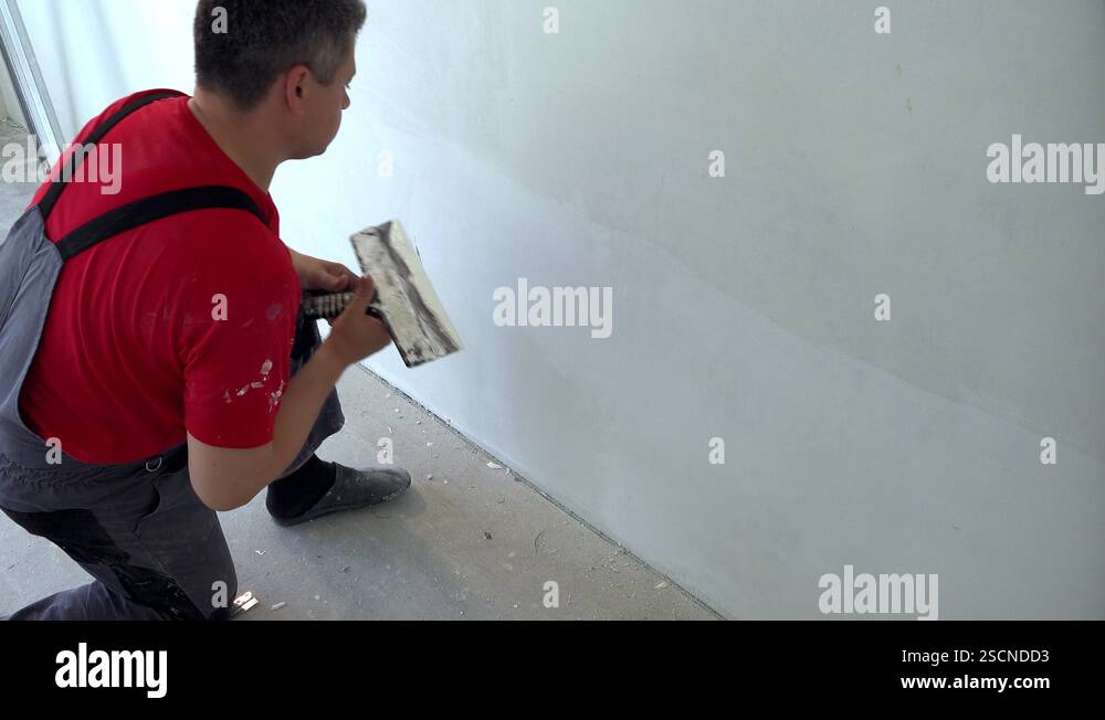 Amateur man do construction finishing works in his house. Do it ...