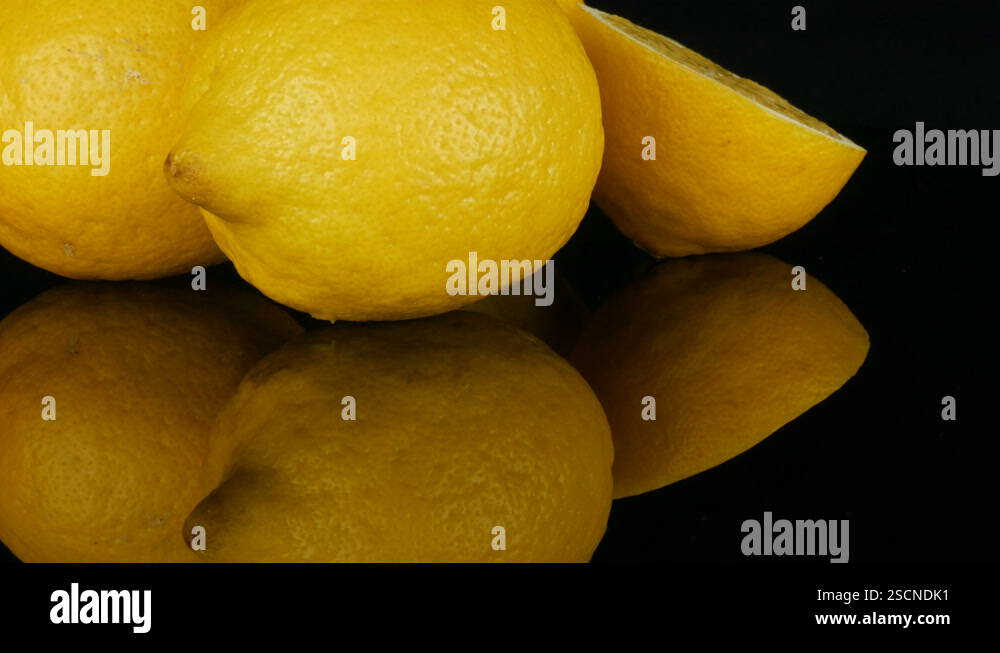 Ripe fresh juicy yellow lemon on black background rotate Stock Video ...