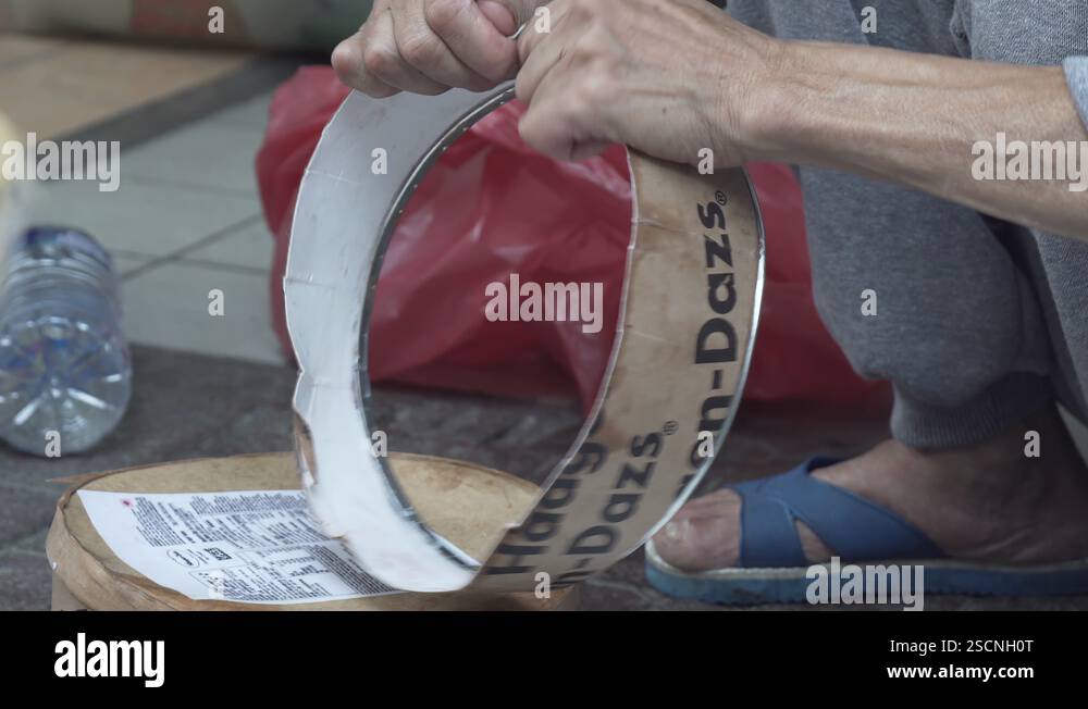 Taipei, Taiwan, April 2019: A man is tearing the paper boxes. Sorting ...
