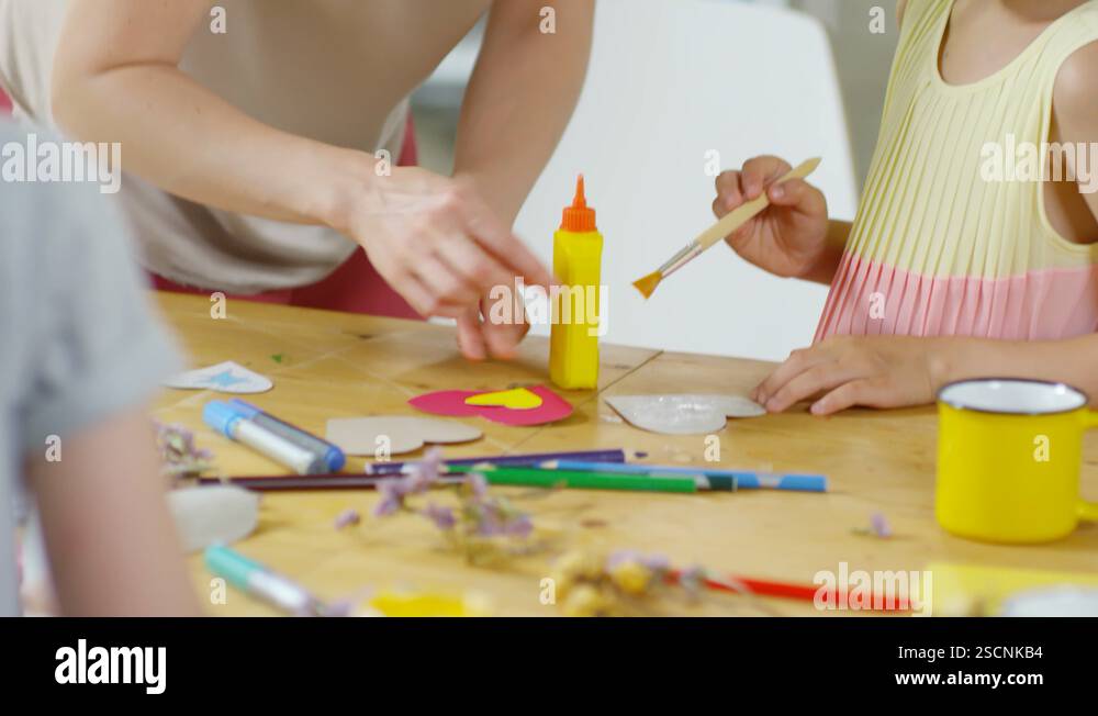 Female Teacher Helping Little Girl to Make Paper Craft Stock Video ...