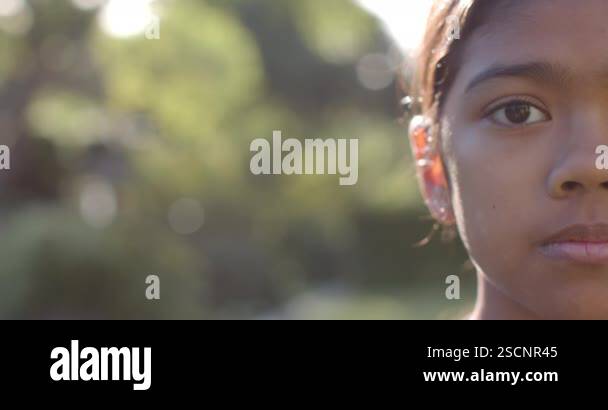 Smiling girl outdoors enjoying sunny day, close-up of face with blurred ...