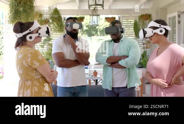 Using VR headsets, group of diverse friends exploring virtual reality ...