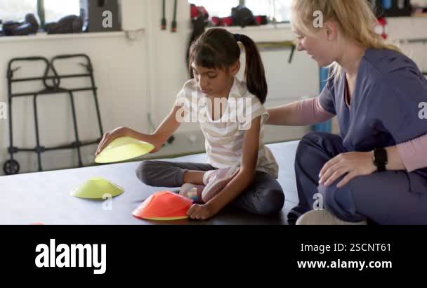girl with cerebral palsy in disability rehab, playing with therapy ...