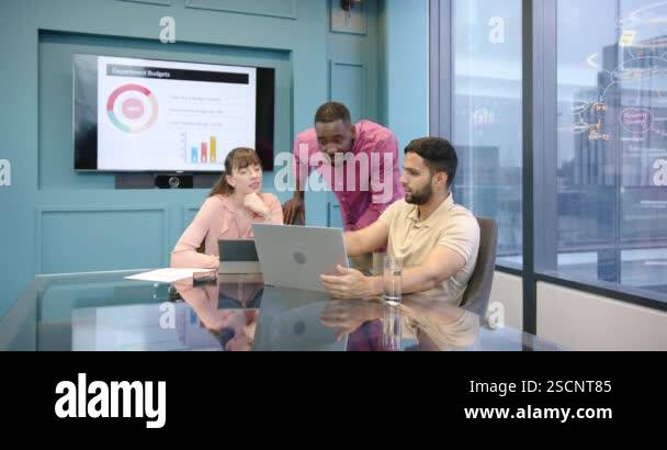 Business team discussing project, using laptop and presentation screen ...