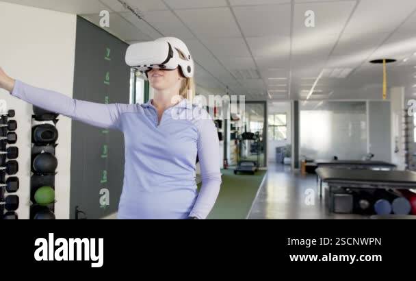 Using VR headset, woman in rehabilitation center engaging in virtual ...