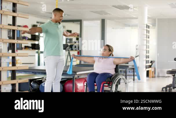 Rehabilitation, therapist using resistance bands assisting woman with ...