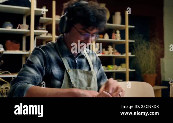 Male potter sculpting clay modeling in ceramics studio handmade hobby ...