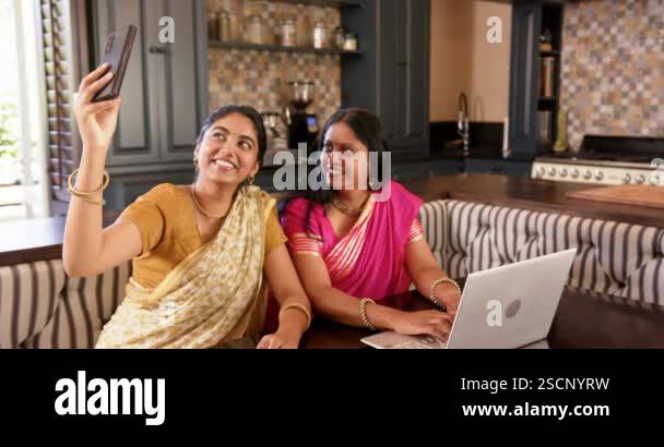 Taking selfie, indian mother and teenage daughter in traditional sari ...