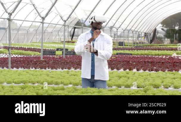 Using VR headset, african american man in white coat inspecting ...