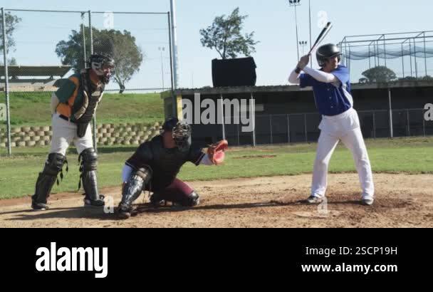 Male baseball players and male umpire playing baseball, catching the ...