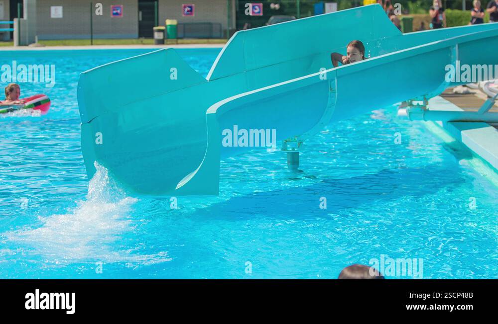 A few girls go down a water slide almost at the same time Stock Video ...