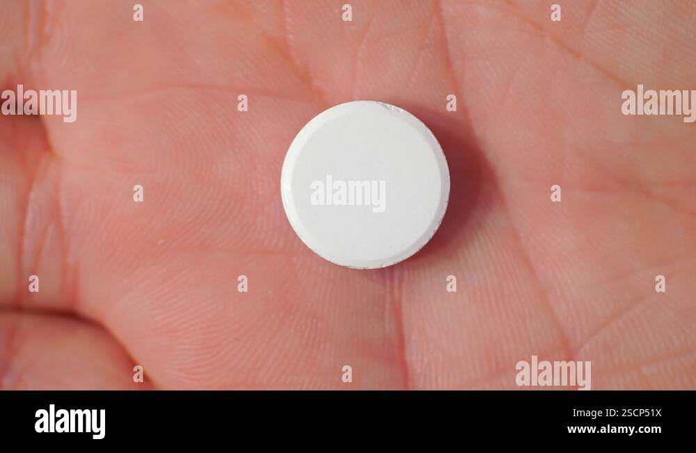 round large white pill lies on the male palm.close-up Stock Video ...
