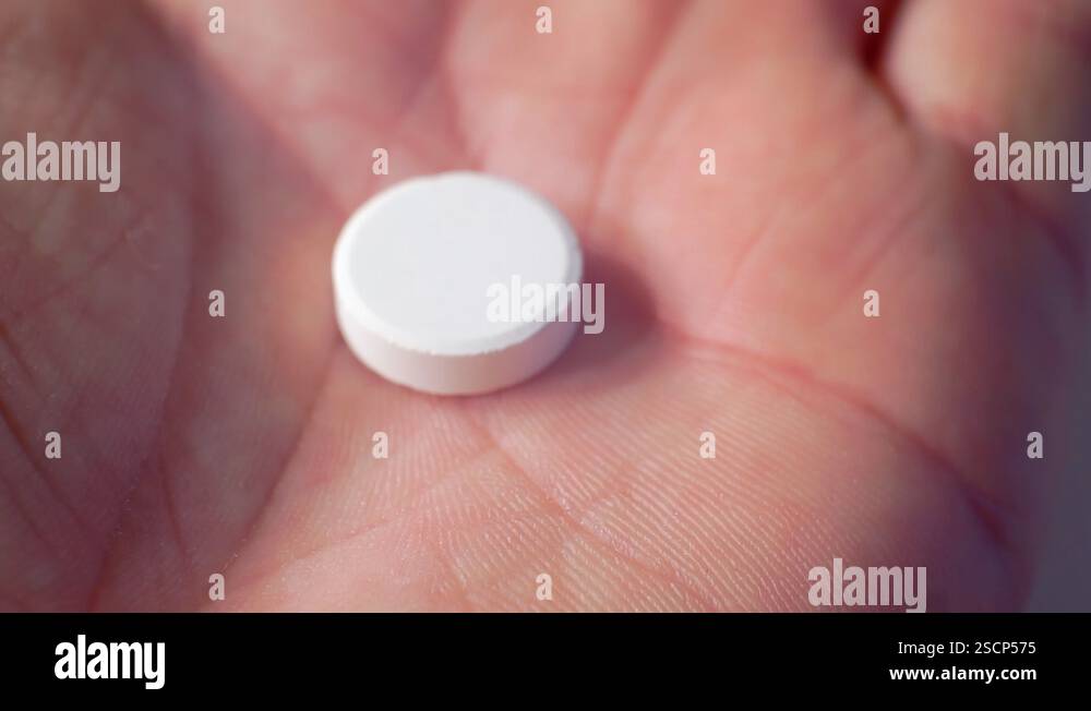 round large white pill lies on the male palm.close-up Stock Video ...