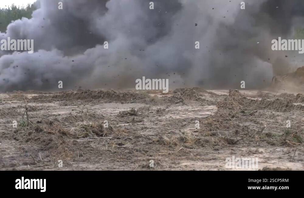 Explosion on the ground in an open muddy field Stock Video Footage - Alamy