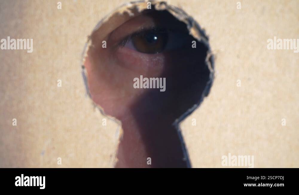 curious human eye looks into the hole in the form of a keyhole Stock ...