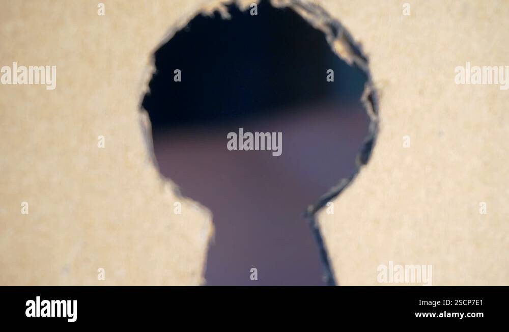 curious human eye looks into the hole in the form of a keyhole Stock ...