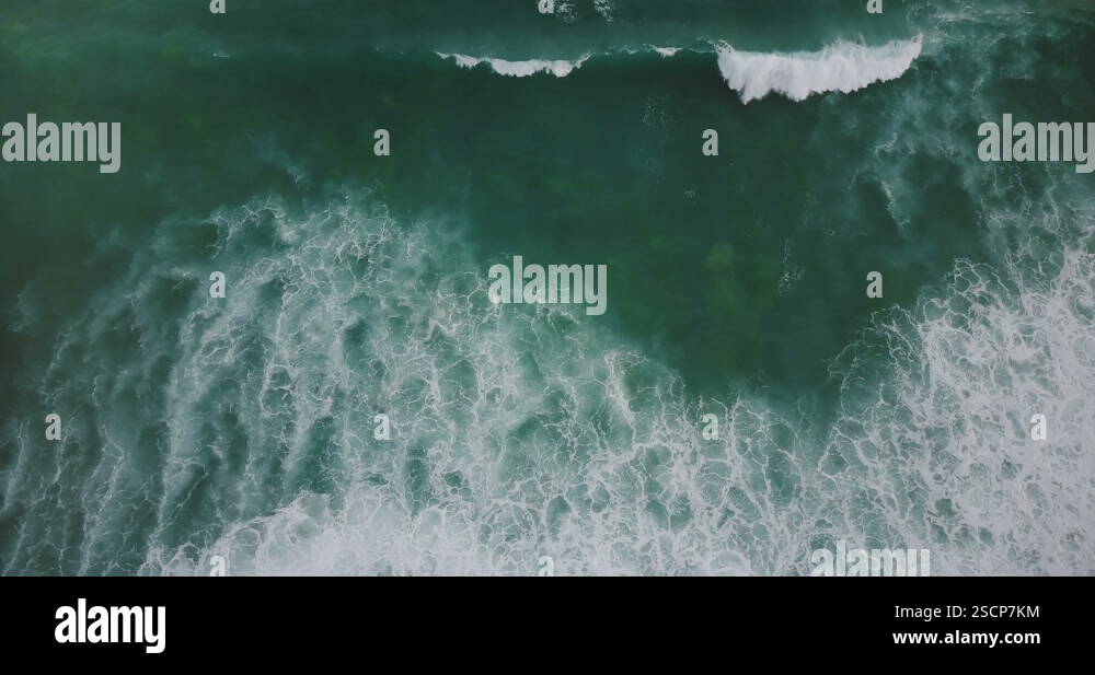 Drone flying right above giant wild rushing sea wave crashing down ...