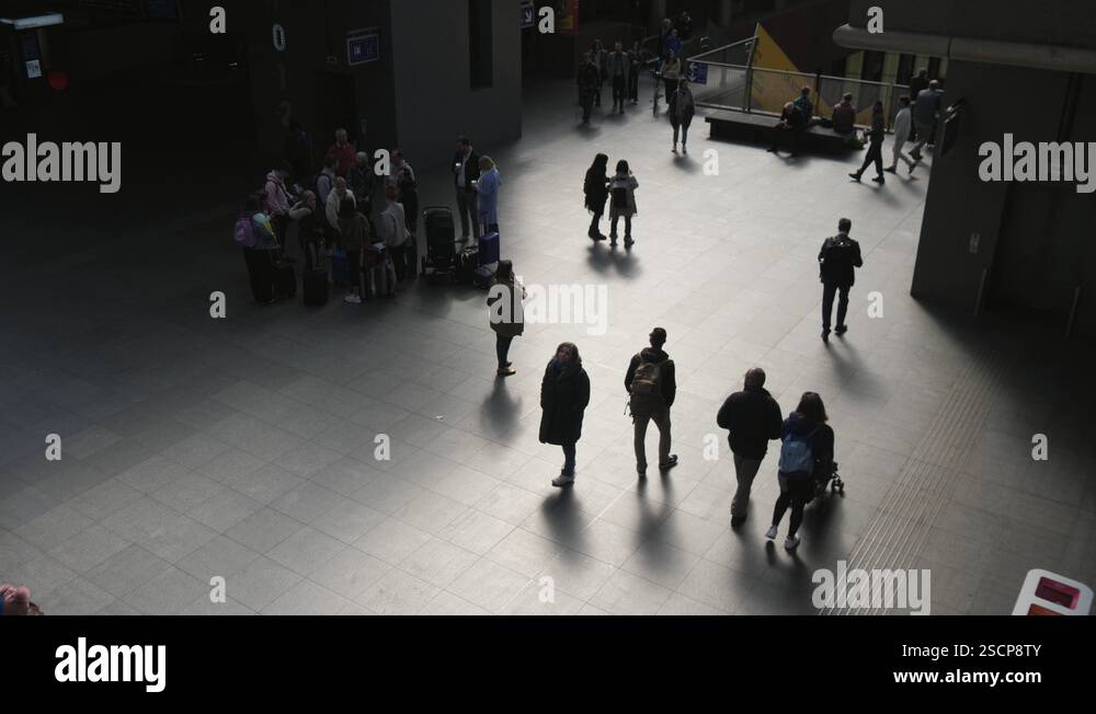 Antwerp terminal with groups of passengers going back and forth inside ...