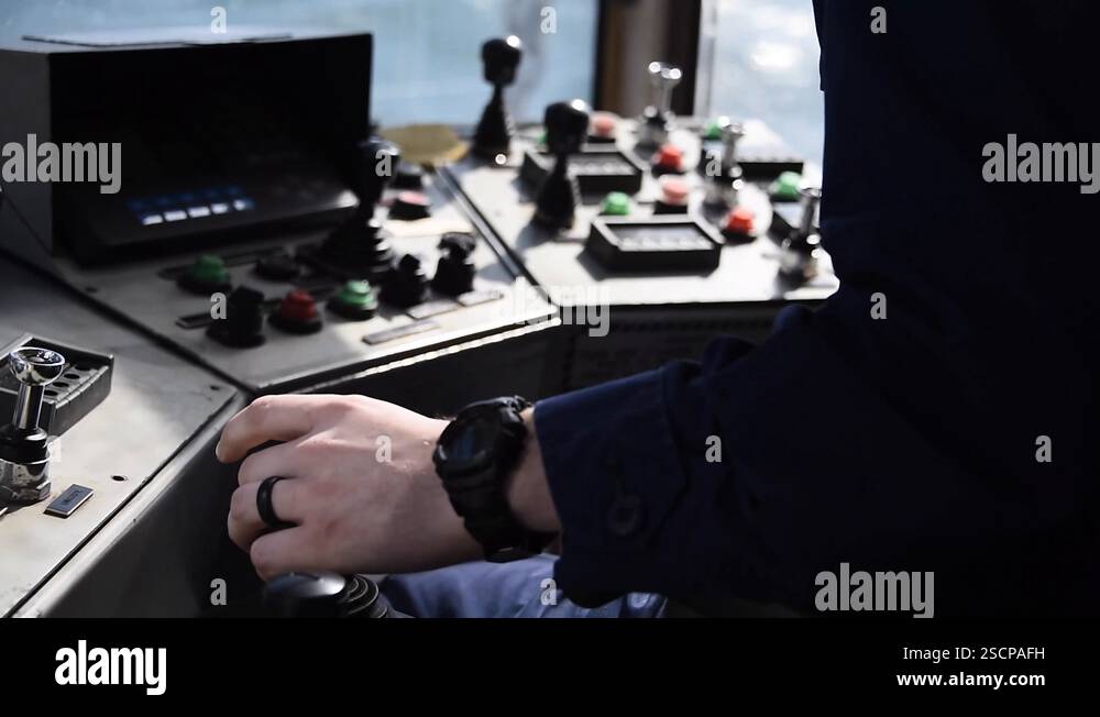Crew operating crane from control room aboard Coast Guard Cutter Aspen ...