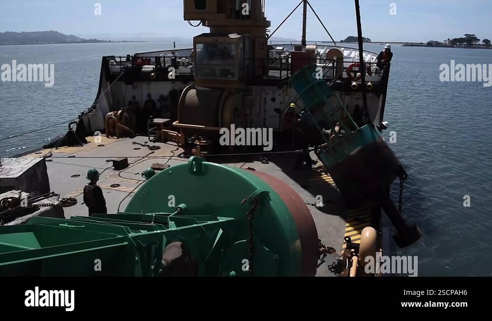 Crew hoist navigational buoy onto deck of Coast Guard Cutter Aspen ...