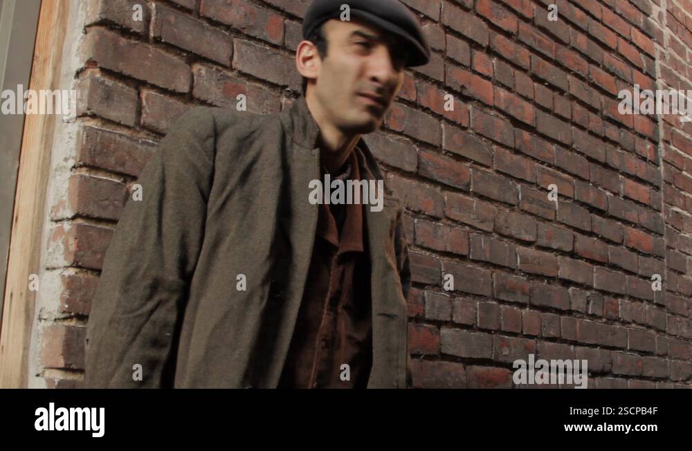 Portrayal of Gangster/Mobsters standing against a brick wall with ...