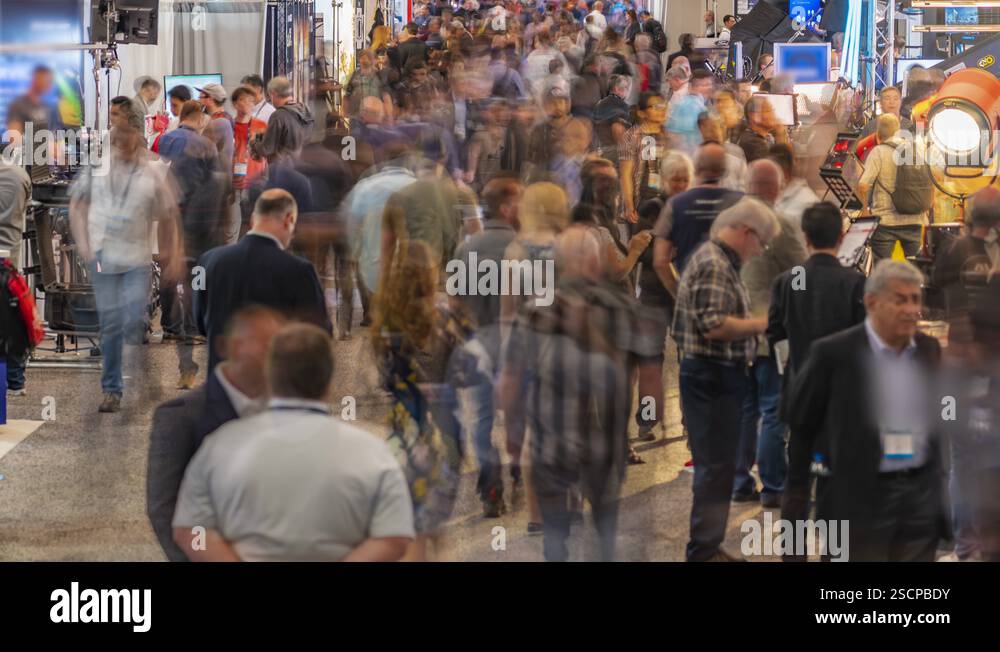 Crowded people attending a trade show at a convention center exhibition ...