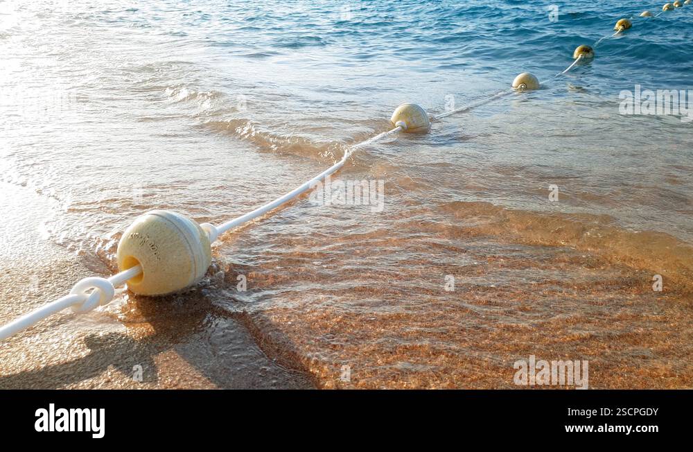 Closeup 4k footage of floating line of buoys in the sea at sunset Stock ...