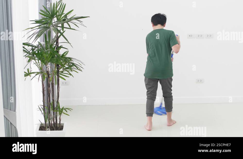 Asian young boy help family cleaning the house using a mop Stock Video ...