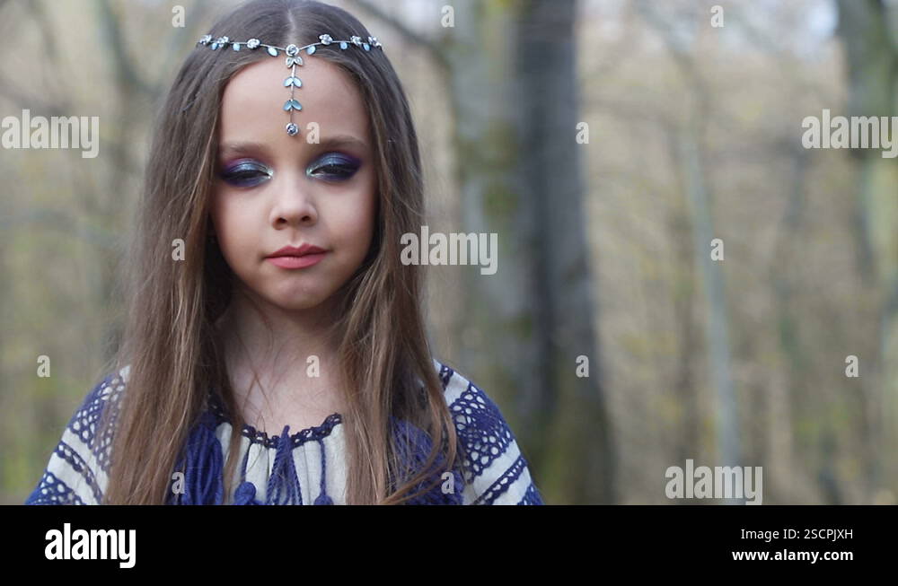 Close-up of the child's face. Little girl looking down and into the ...