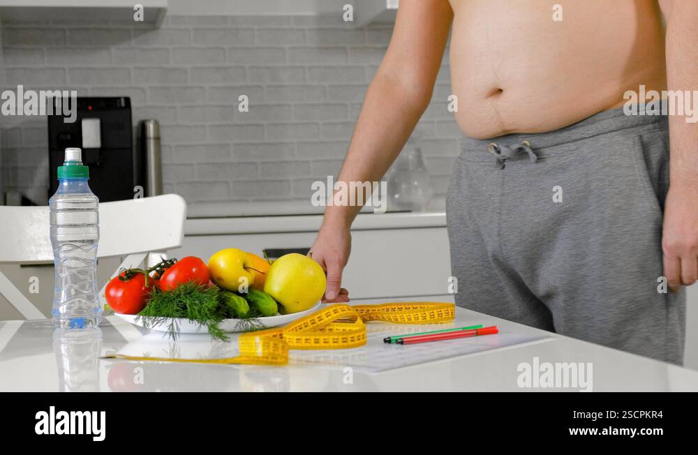 fat man measuring his waist, healthy eating, healthy lifestyle concept ...