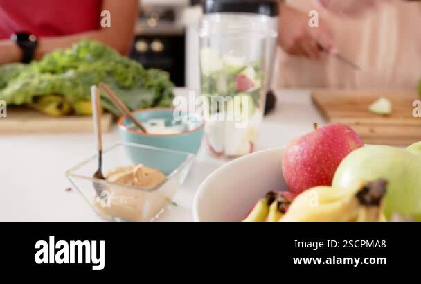 Preparing healthy smoothie, person adding ingredients to blender in ...