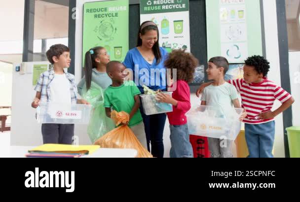 In school, teacher and children recycling plastic, glass, and paper ...